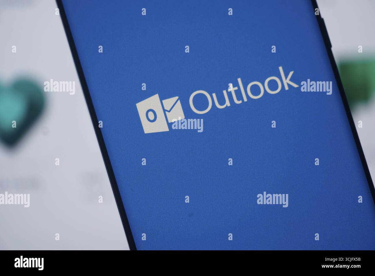 Outlook app logo shown on a smartphone screen in blue Stock Photo - Alamy