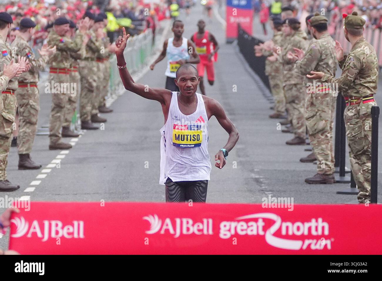 Alex Mutiso crosses the finish line in first place to win the Elite ...