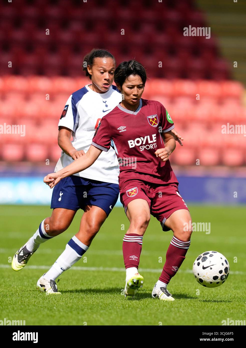 Tottenham Hotspur's Drew Spence (left) and West Ham United's Riko Ueki battle for the ball ...