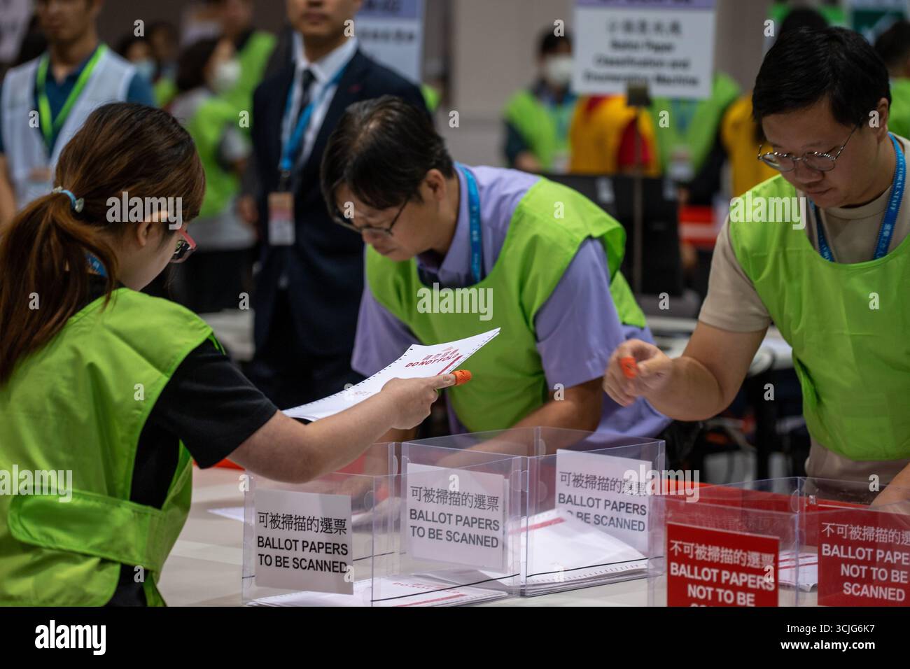 Voting station workers sorting ballots on the table at the ballot ...