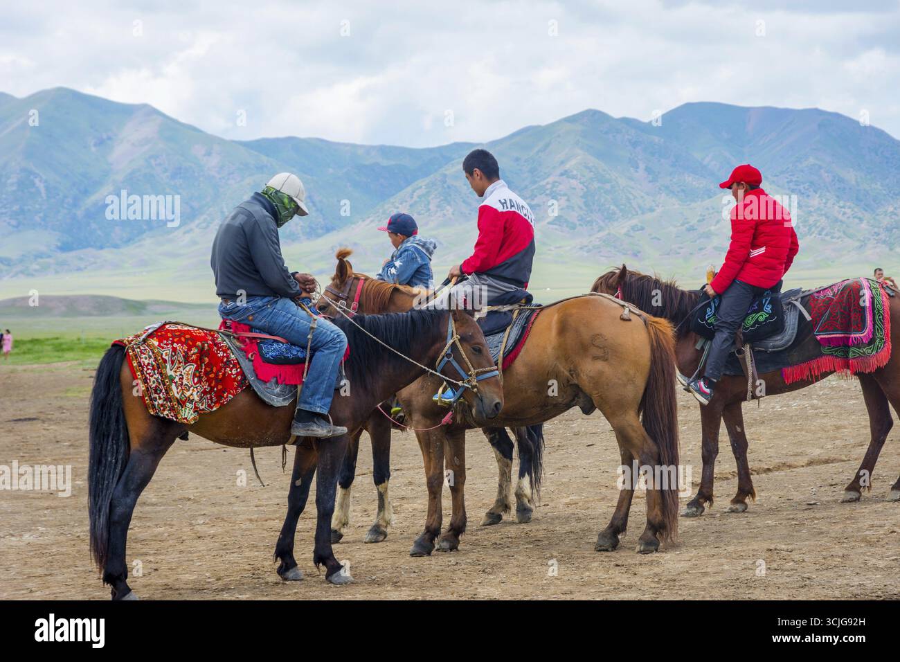 BOLE, CHINA - JULY 4: Group of horse riders resting by the Sayram lake ...