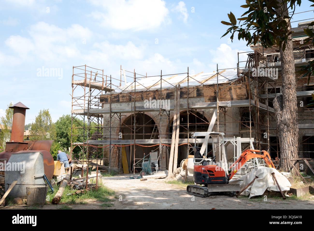 Historic Italian brick building under renovation, surrounded by ...