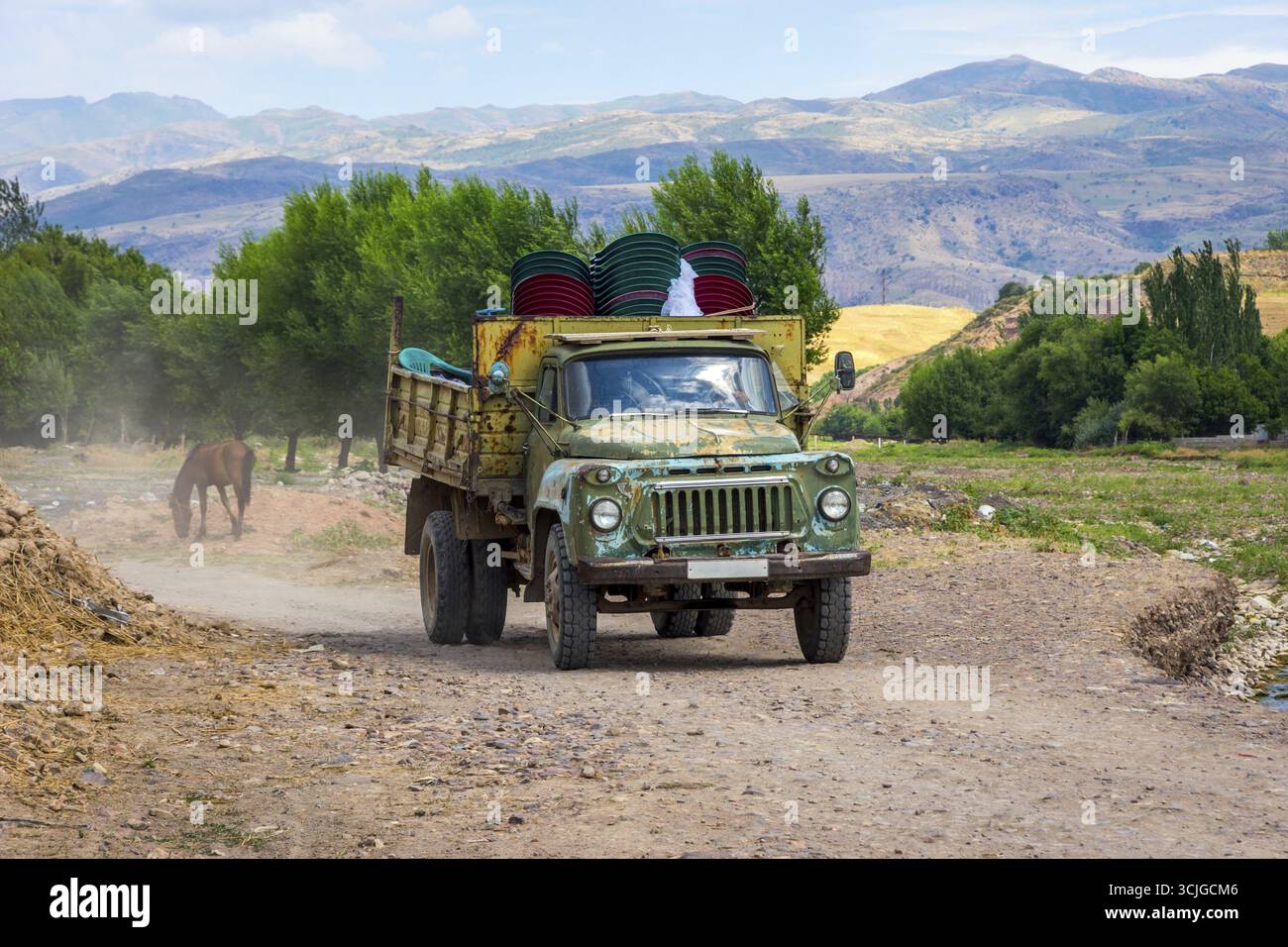 Old loaded soviet truck driving on local road in Kazakh steppe Stock ...