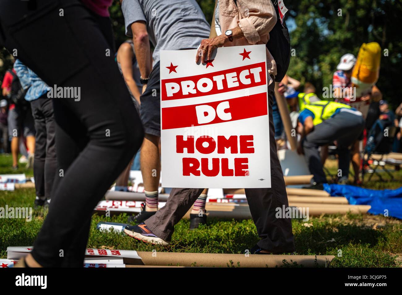 Demonstrators pick up protest signs at Malcolm X Park in Washington, DC ...