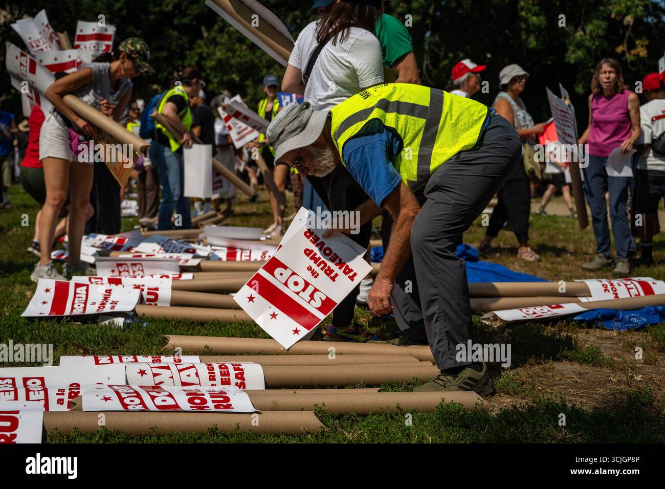 Demonstrators pick up protest signs at Malcolm X Park in Washington, DC ...