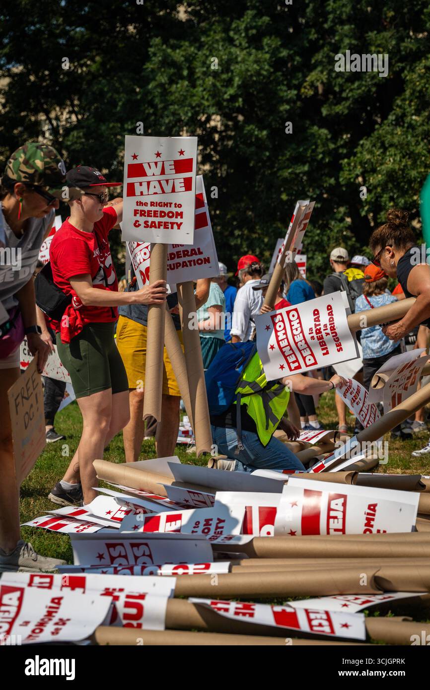 Demonstrators pick up protest signs at Malcolm X Park in Washington, DC ...