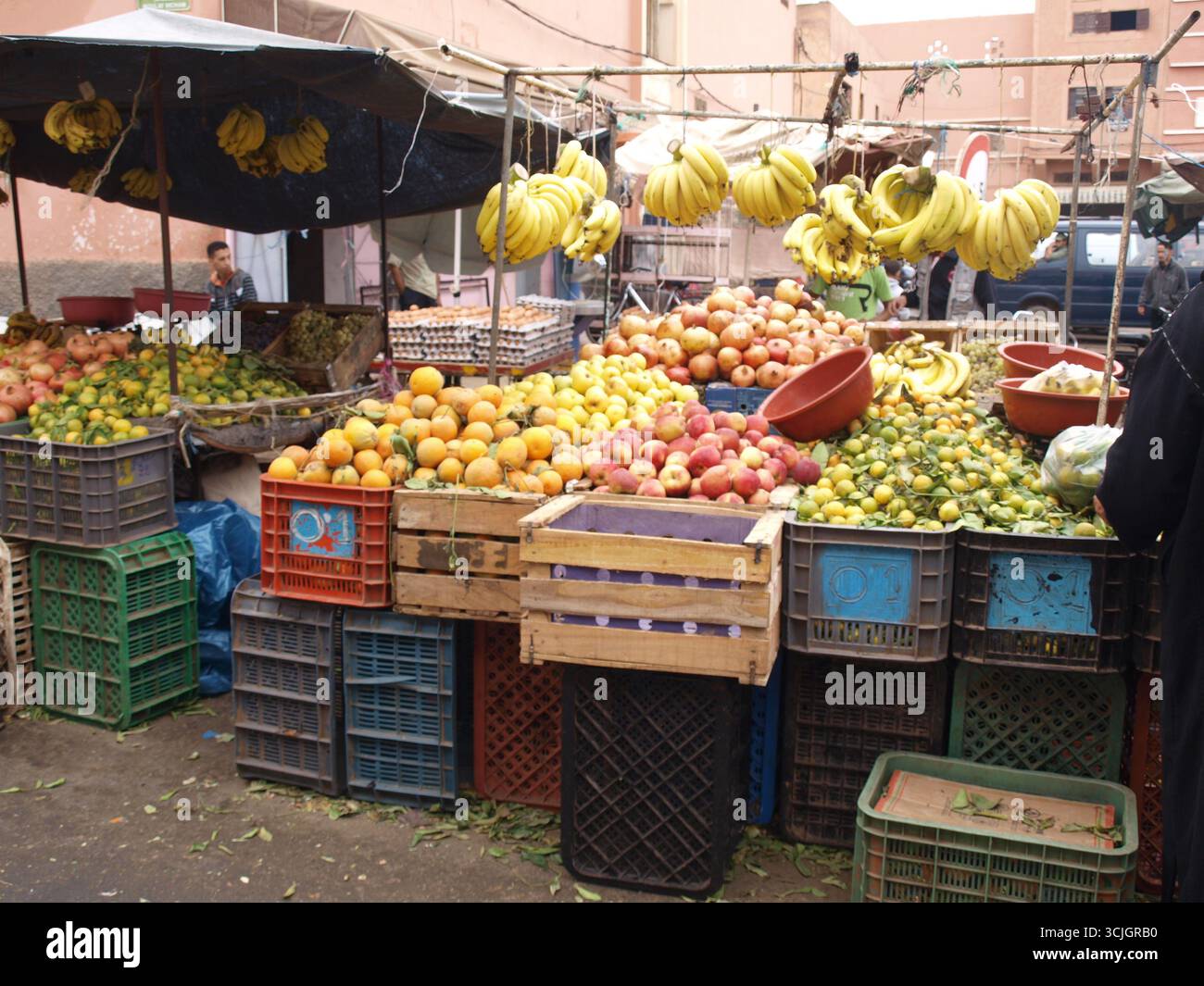 A traditional Moroccan souk stall displaying fresh dates, lemons, and ...