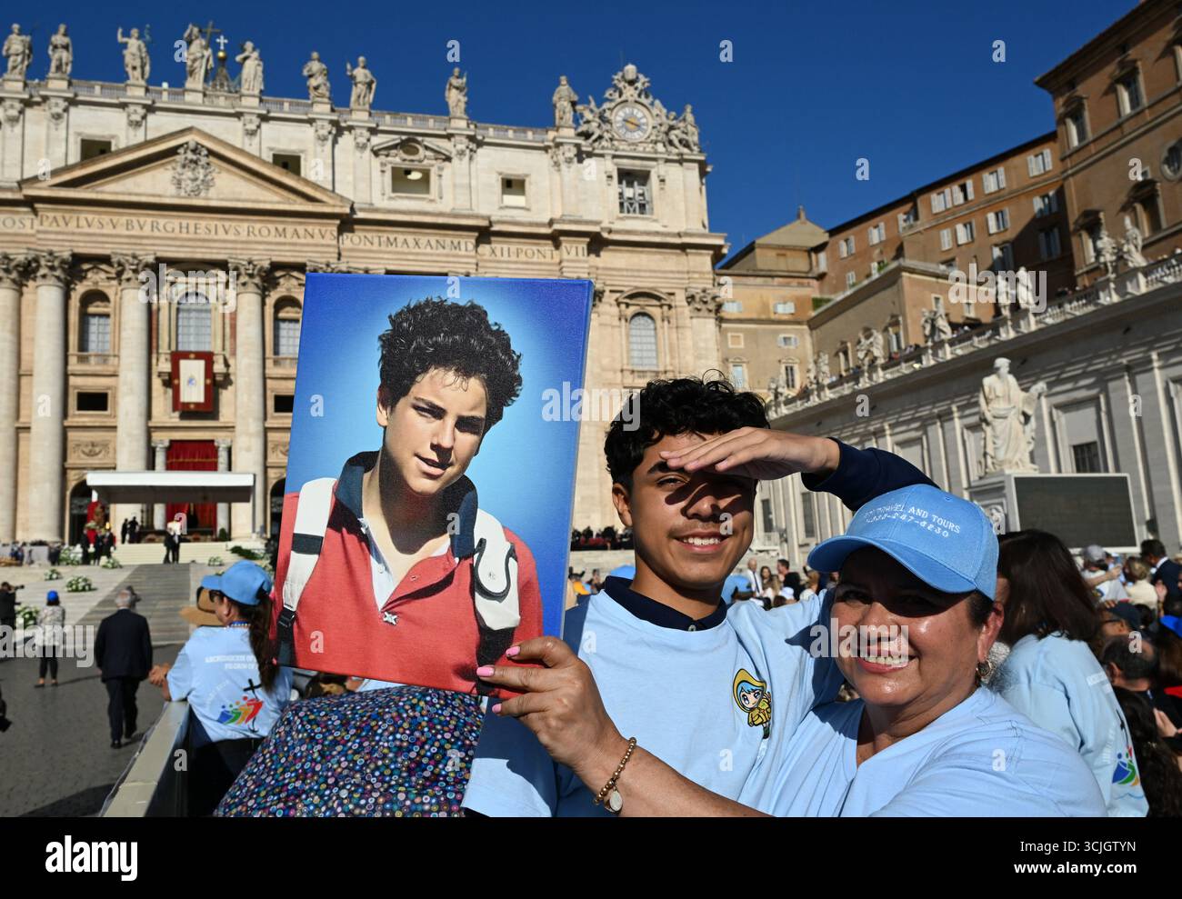 A pilgrim holds the portrait of new saint Carlo Acutis as Pope Leo XIV ...