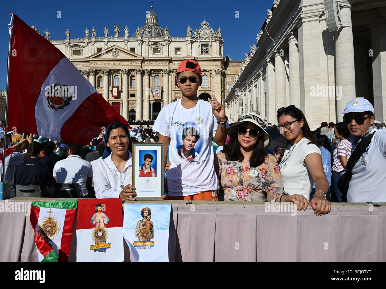 Pilgrims show the portrait of new saint Carlo Acutis as Pope Leo XIV ...