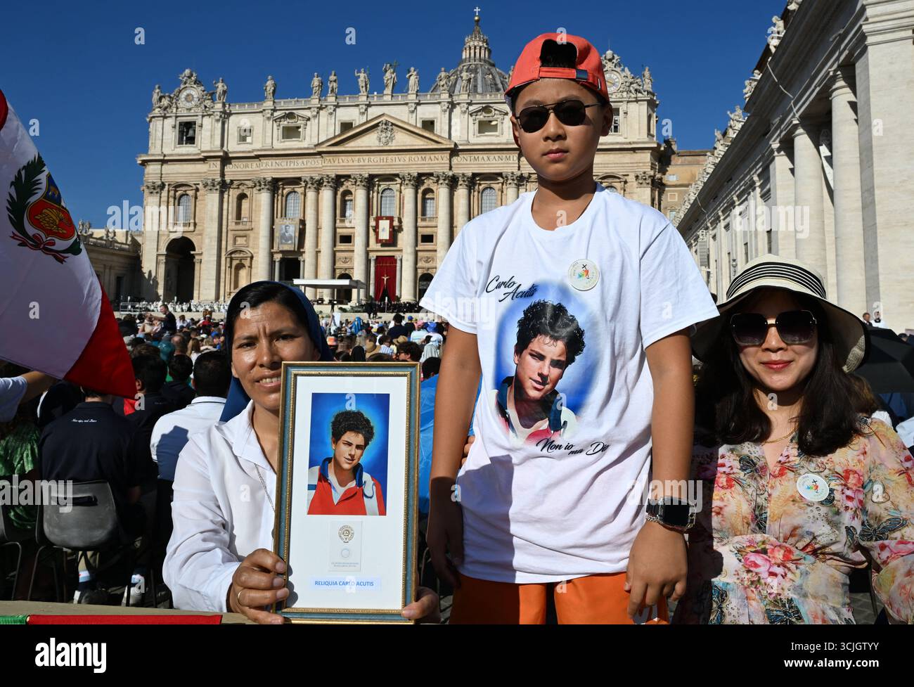Pilgrims show the portrait of new saint Carlo Acutis as Pope Leo XIV ...