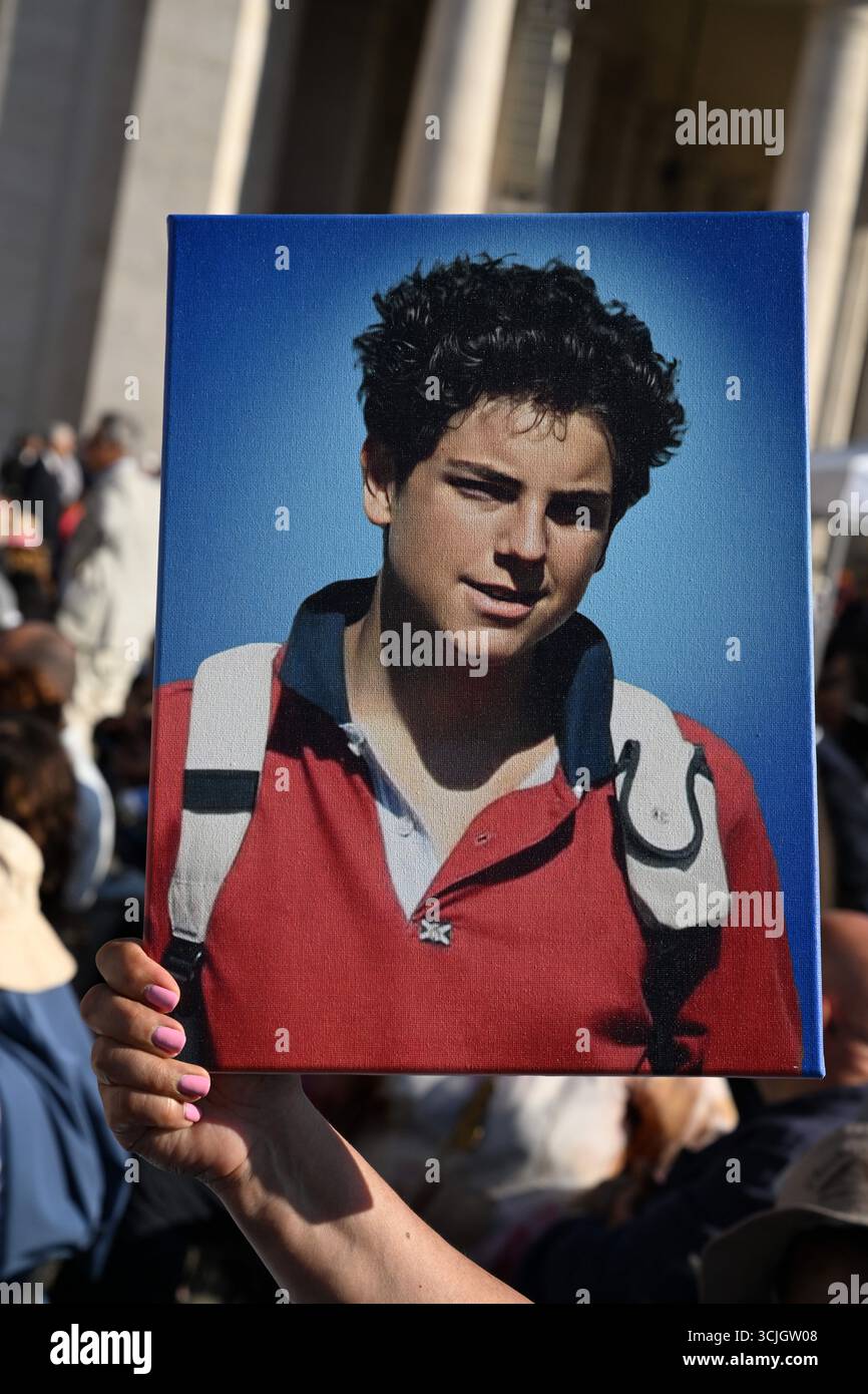 A pilgrim holds the portrait of new saint Carlo Acutis as Pope Leo XIV ...
