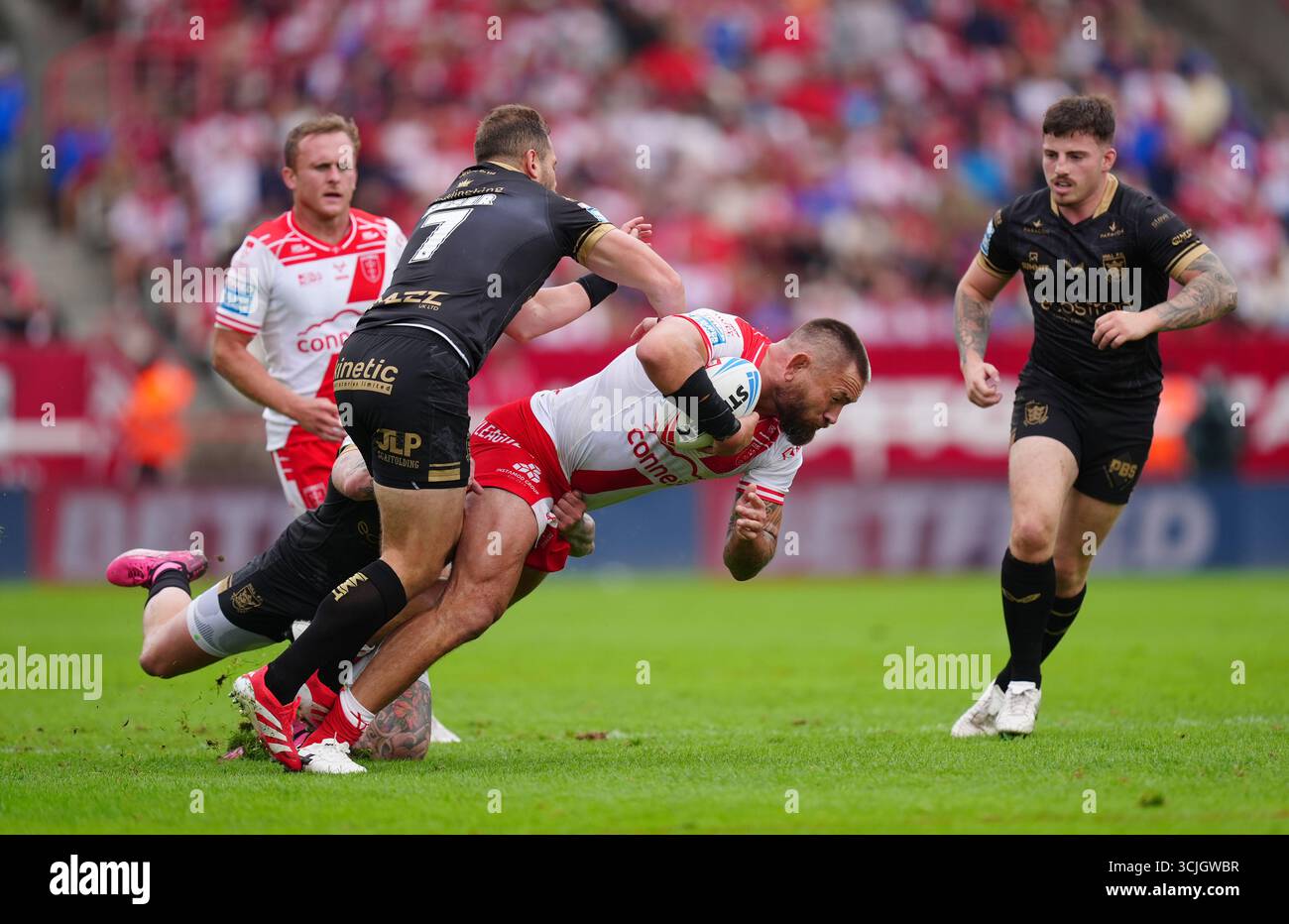 Hull KR's Jared Waerea-Hargreaves is tackled by Hull FC's Zak Hardaker ...