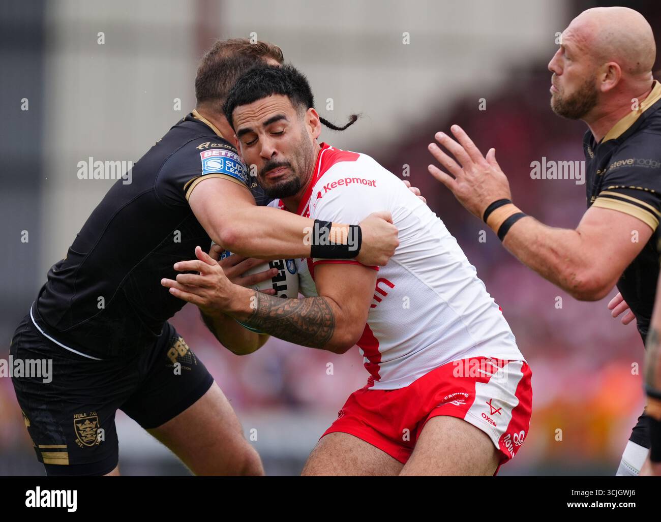 Hull KR's Tyrone May is tackled by Hull FC's Aidan Sezer during the ...