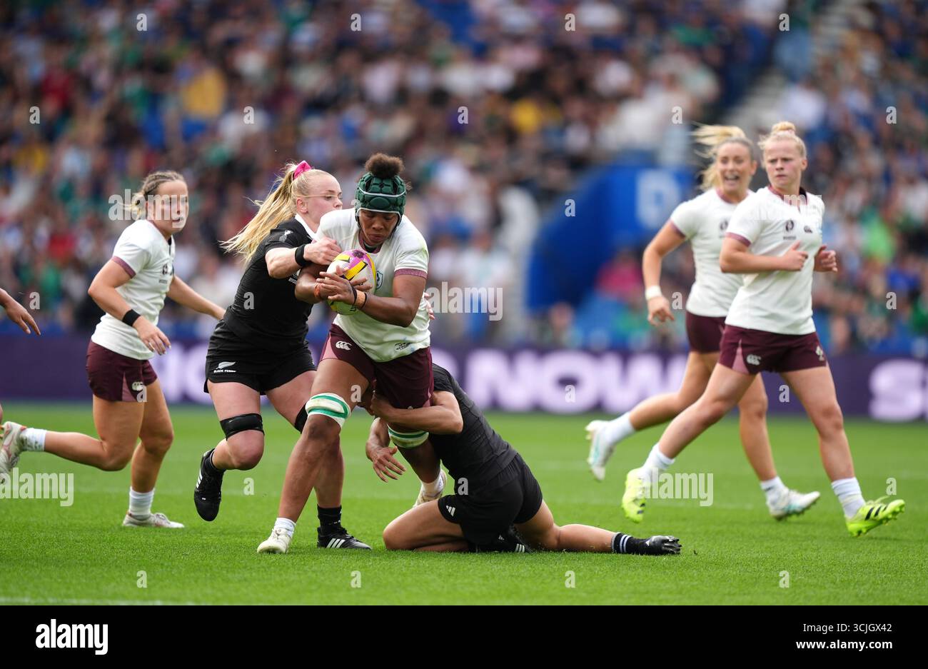 Ireland's Grace Moore (centre) is tackled by New Zealand's Jorja Miller ...