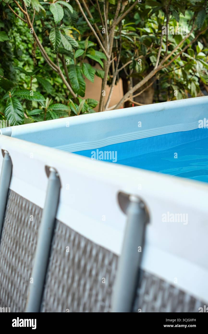 Fragment of a family's swimming pool in the backyard on a hot day in a ...