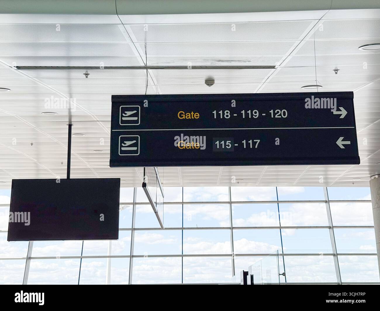 Airport directional sign with gates information in terminal hall ...