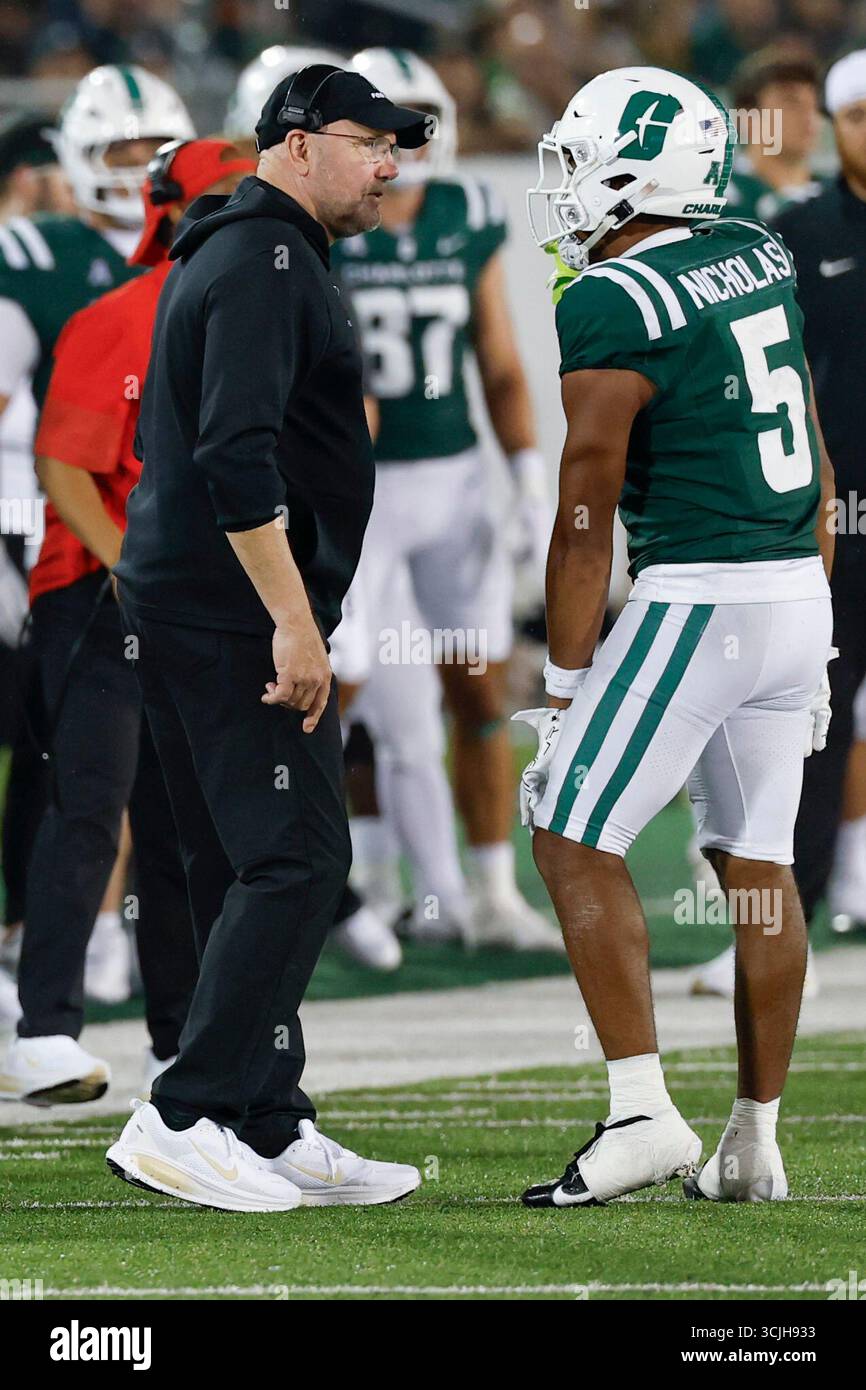 Charlotte wide receiver Javen Nicholas (5) talks to Charlotte head ...