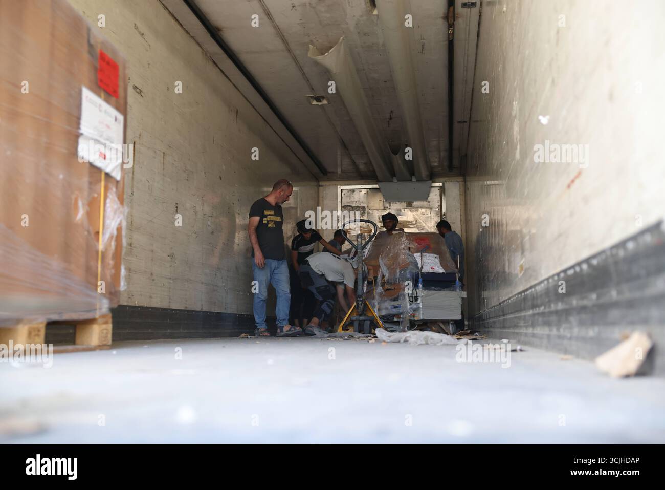 Relief workers unload Qatari medical aid shipment in Damascus to ...