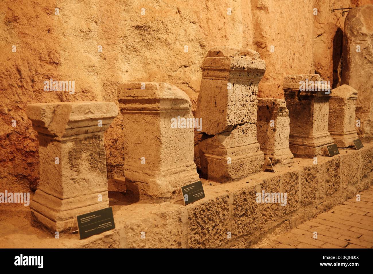 Row of ancient stone altars with inscriptions in the underground museum ...