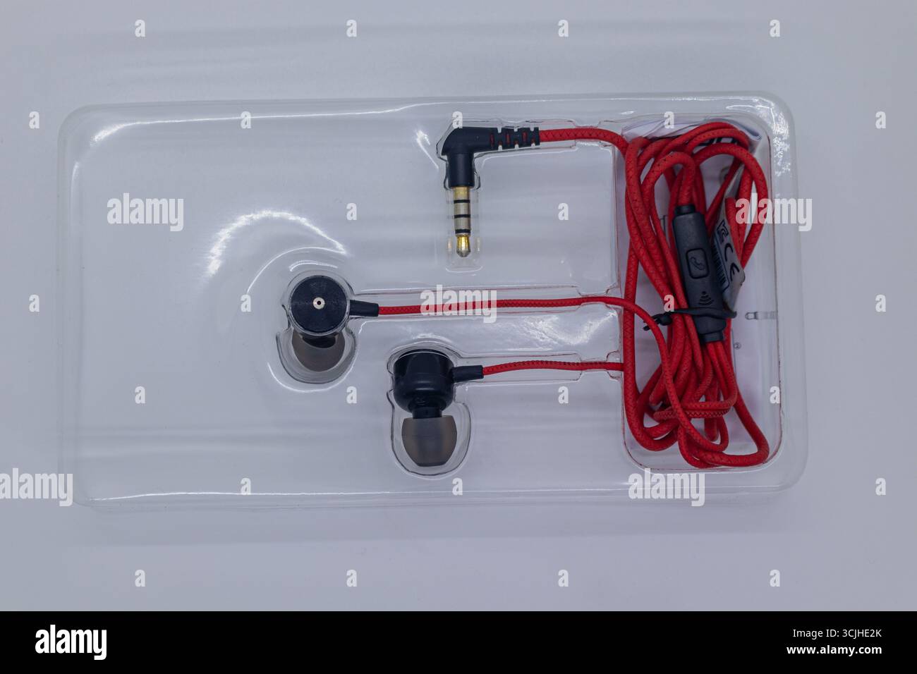 Red Wired In-Ear Earphones with Microphone in Plastic Packaging on ...