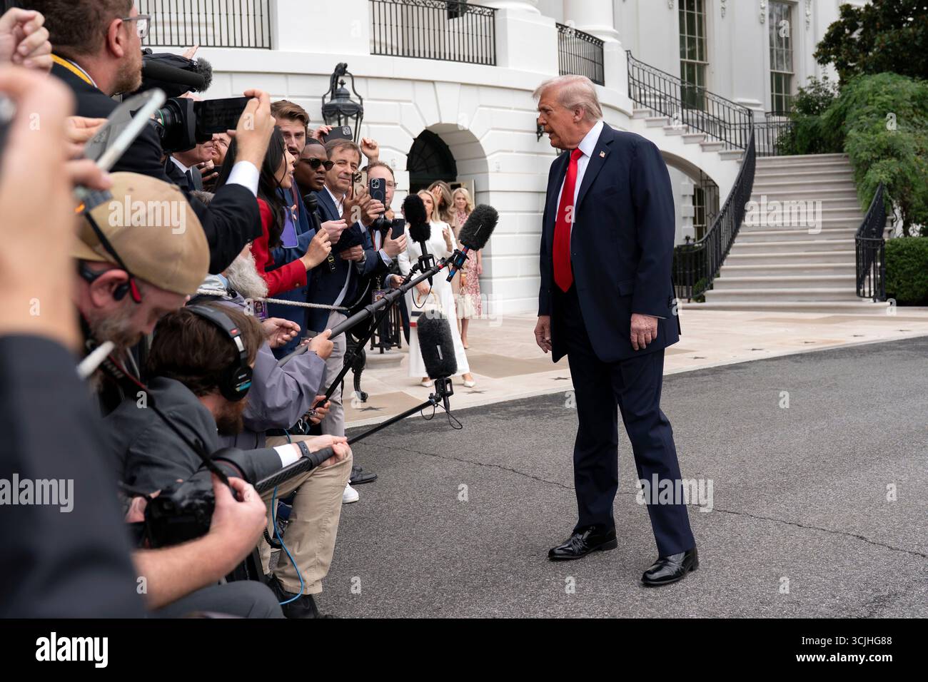 President Donald Trump speaks to reporters as leaves the White House in ...