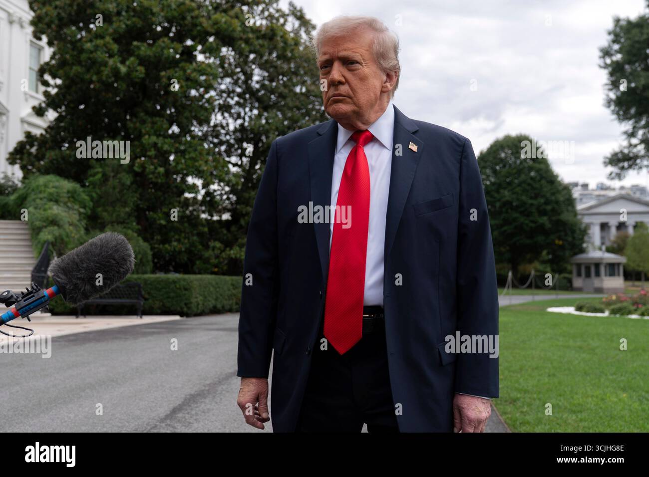 President Donald Trump speaks to reporters as leaves the White House in ...