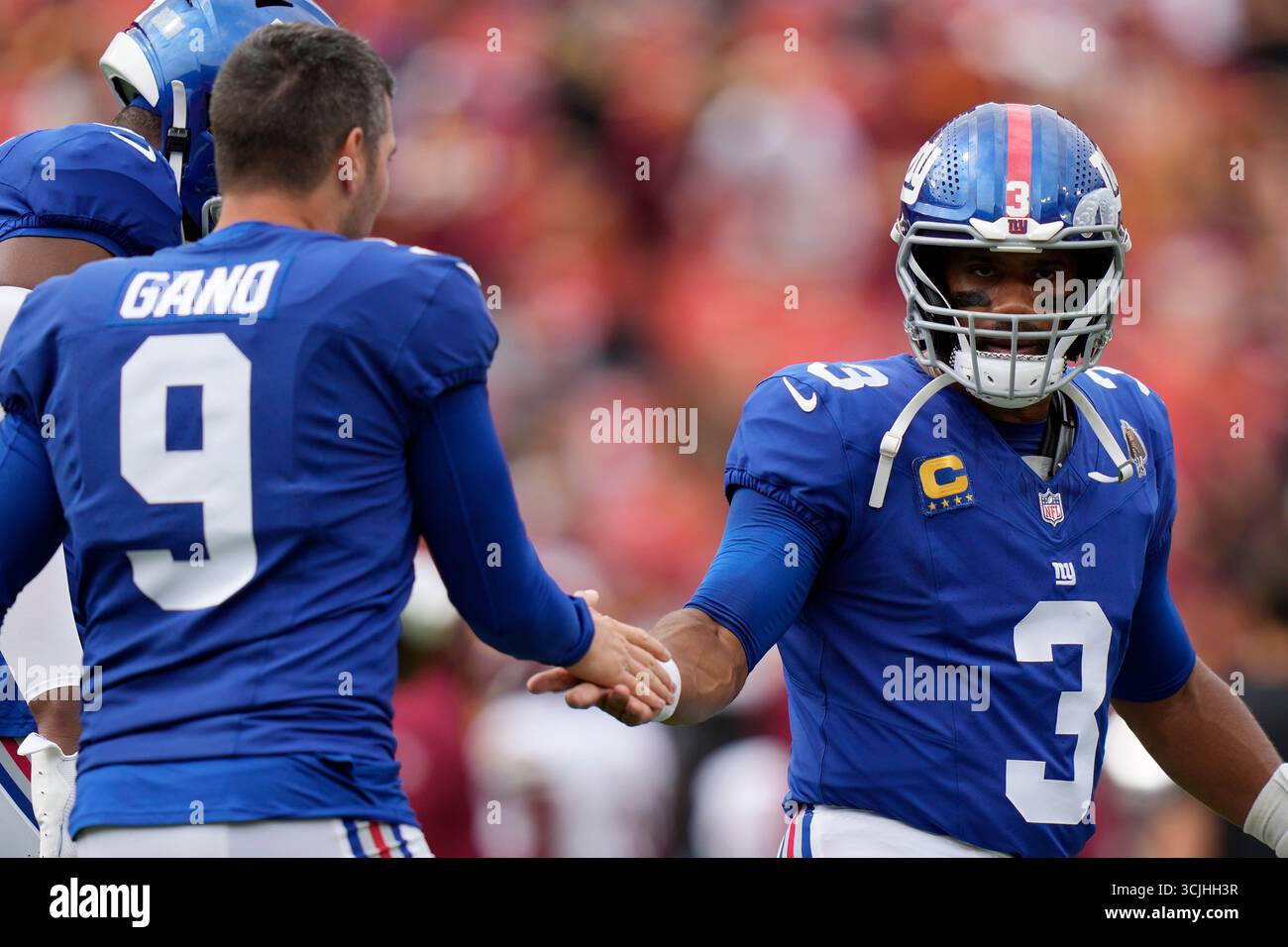 New York Giants quarterback Russell Wilson (3), greets place kicker ...
