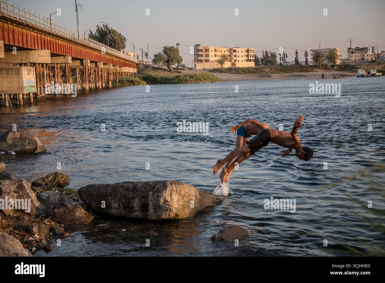 June 4, 2025, Raqqa, Syria: Children dive into the Euphrates river at ...