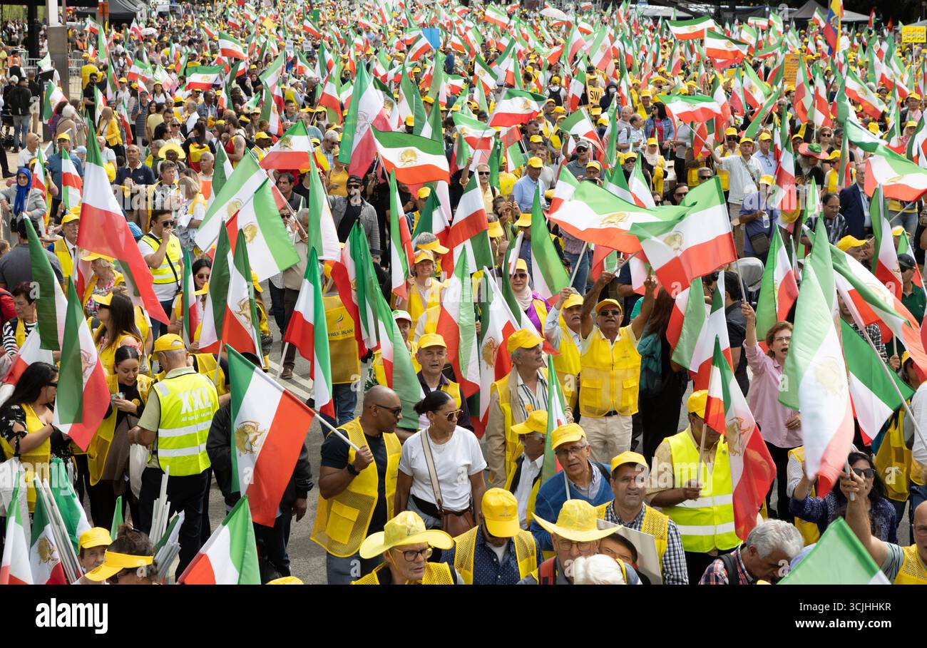 Demonstrators wave Iranian flags during the Free Iran rally. Tens of thousands of Iranians and ...