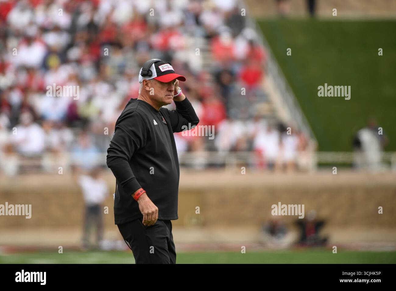 Texas Tech head coach Joey McGuire walks on the field after a score ...