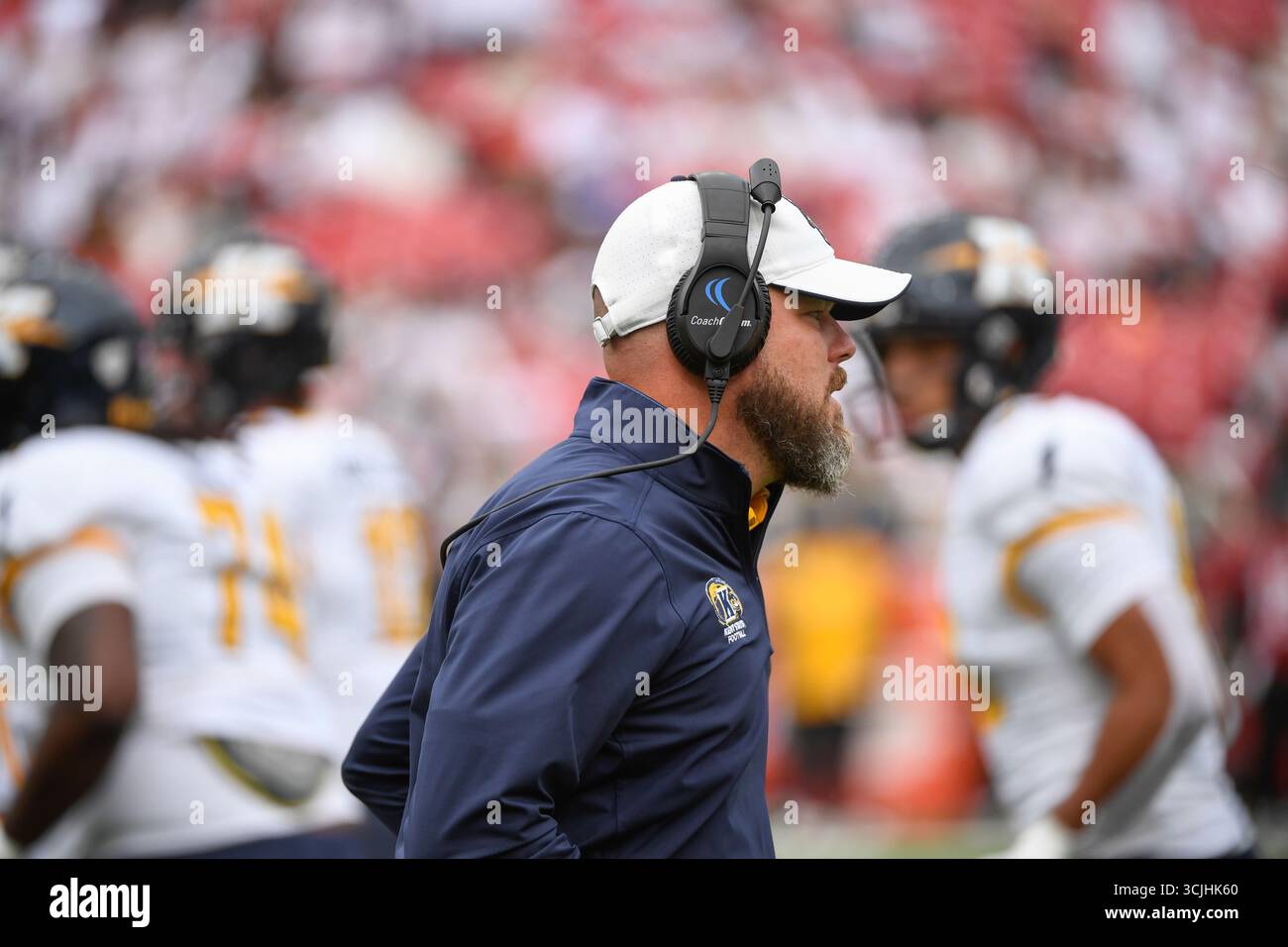 Kent State interim head coach Mark Carney jogs to the sideline after a ...