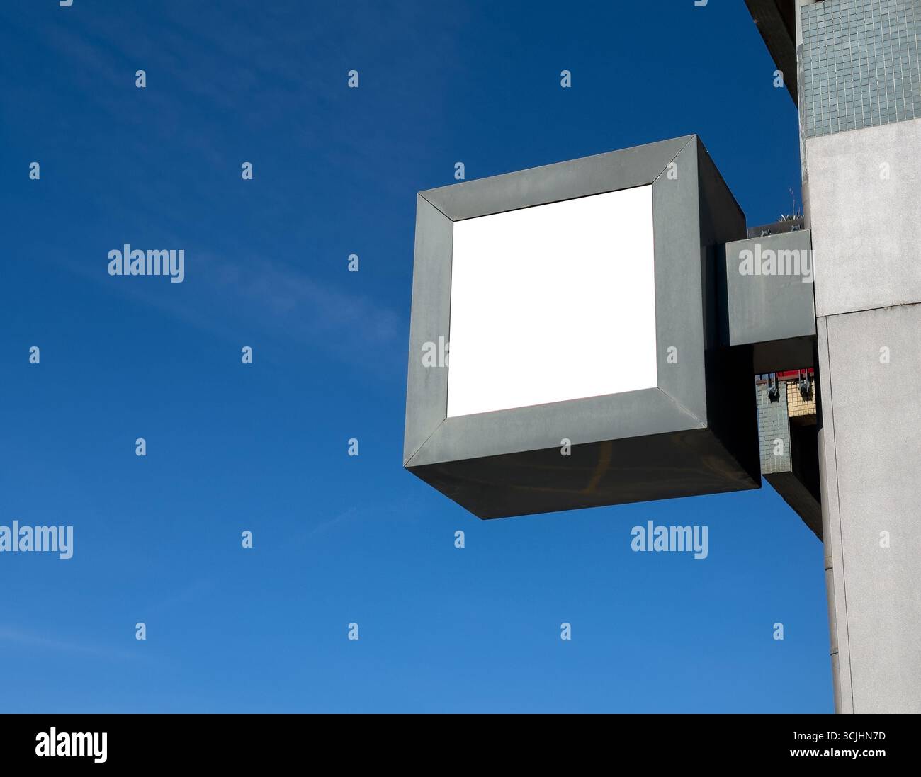 Empty square shop sign mockup mounted on store building with clear blue ...