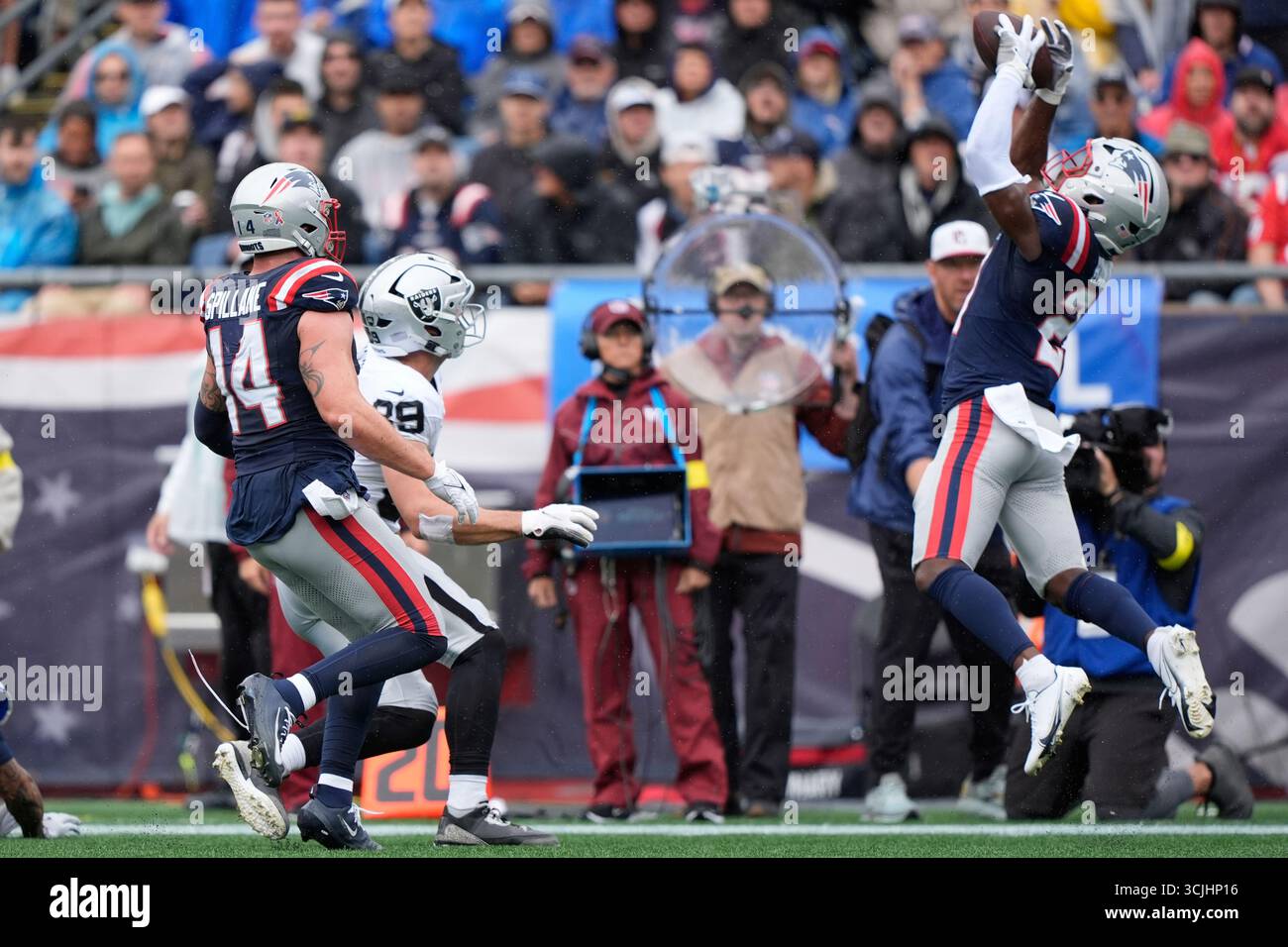 New England Patriots safety Jaylinn Hawkins (21) makes an interception ...