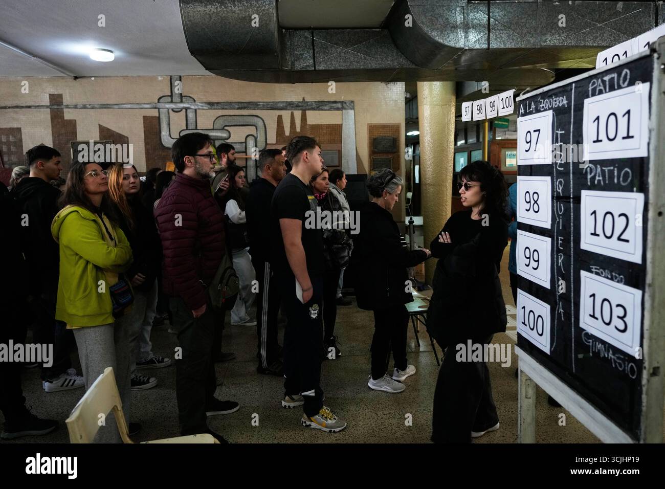 Voters line up to cast their ballots during legislative provincial ...