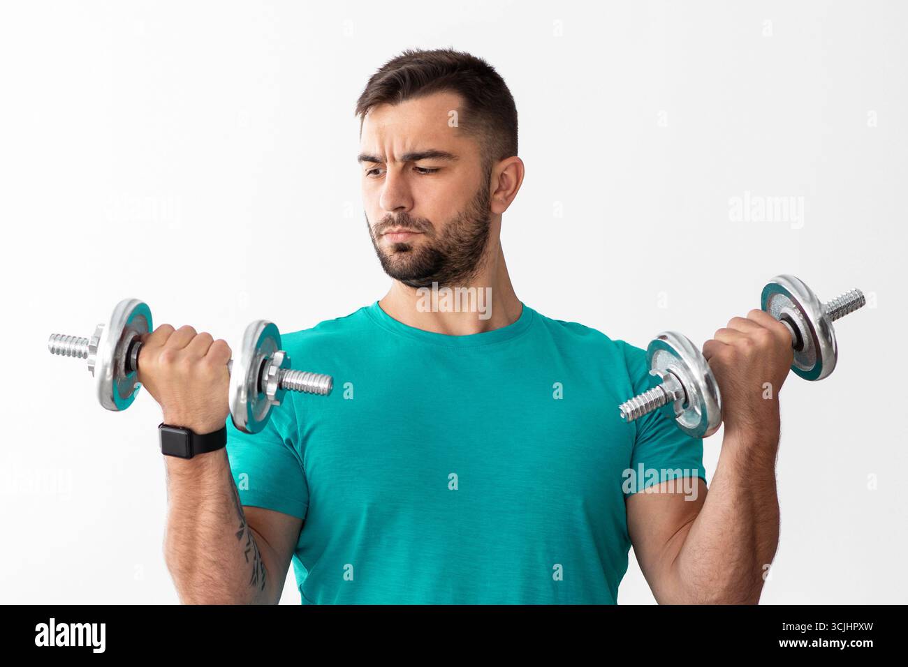 Serious millennial european male athlete in blue t-shirt do strength ...