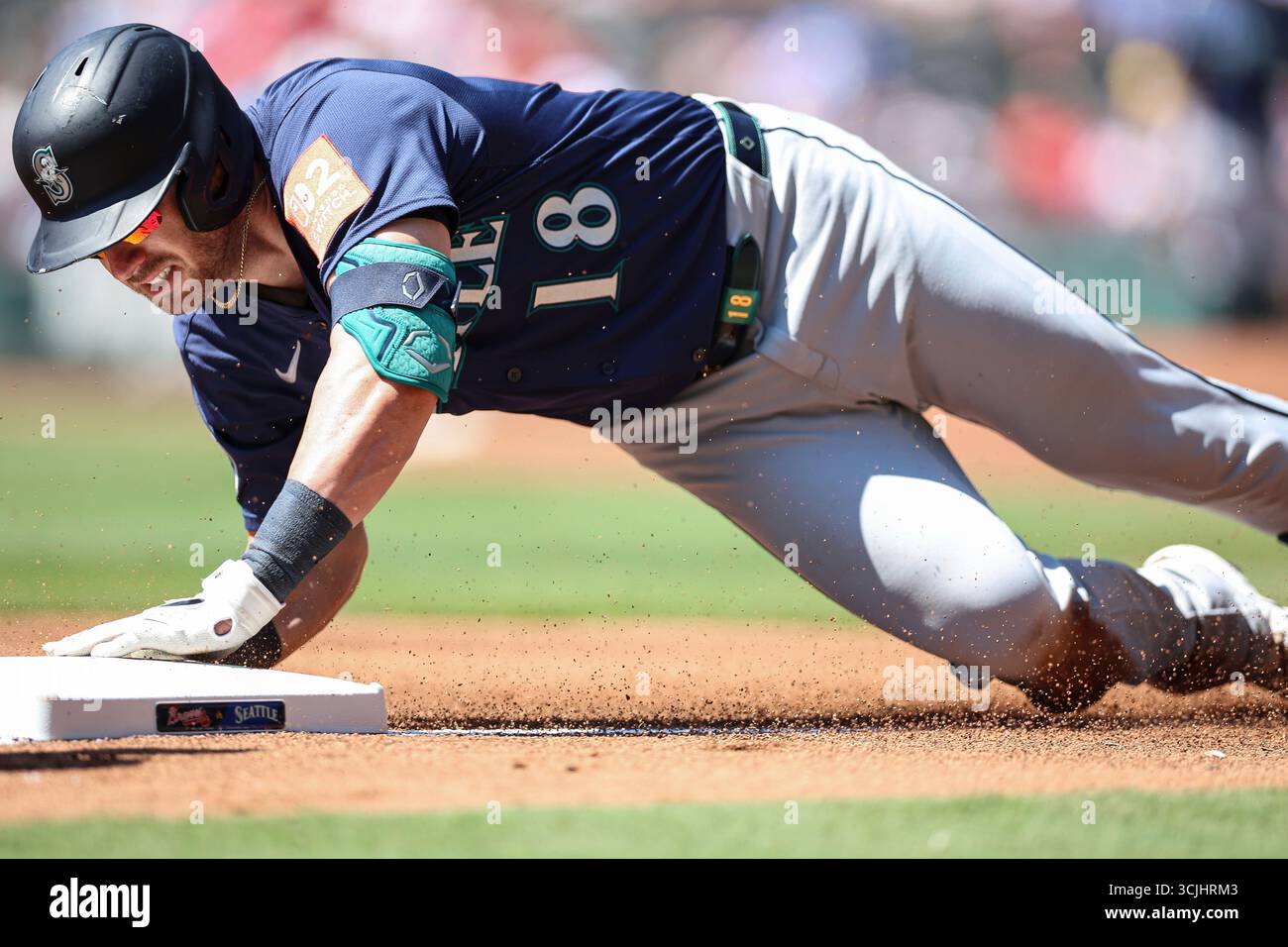 Seattle Mariners' Mitch Garver (18) slides into third base with a ...