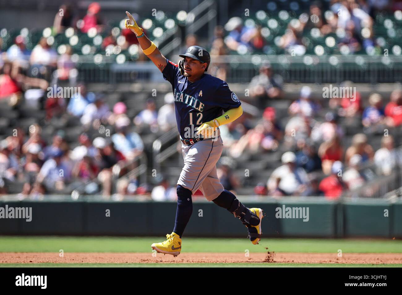 Seattle Mariners' Josh Naylor (12) hits a solo home run in the third ...