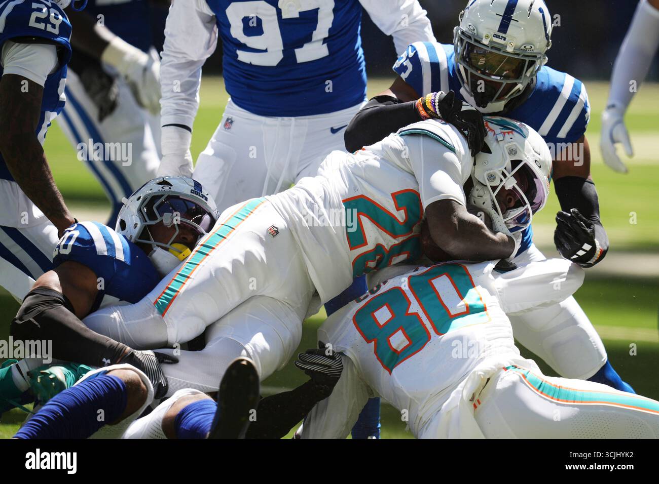 Miami Dolphins running back De'Von Achane (28) is tackled by ...