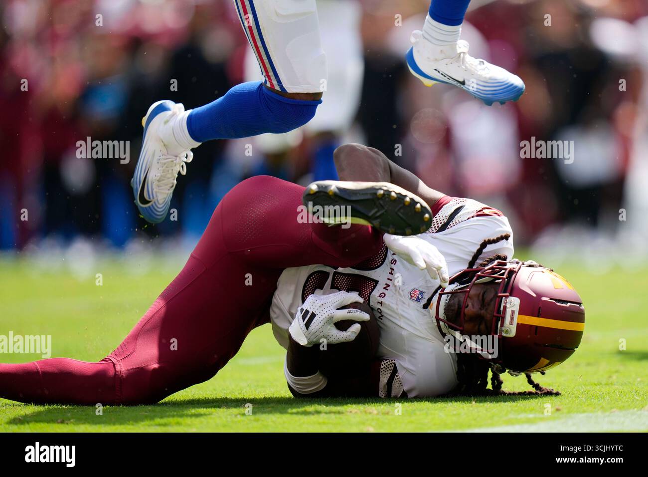 Washington Commanders wide receiver Noah Brown (85) falls to the ground ...