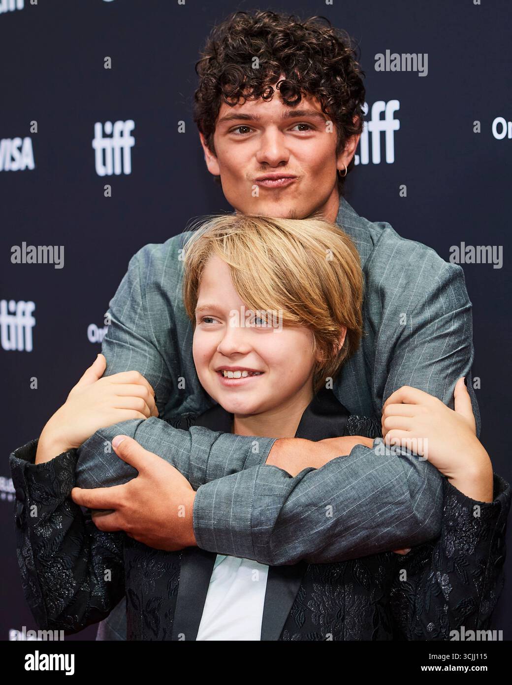 Actors Jacobi Jupe (bottom) and Noah Jupe are photographed on the red ...