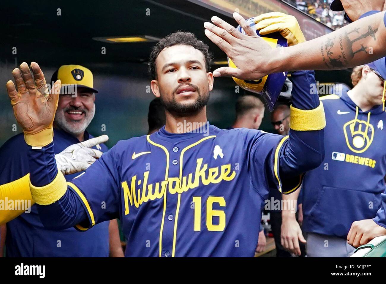 Milwaukee Brewers' Blake Perkins (16) celebrates in the dugout after ...