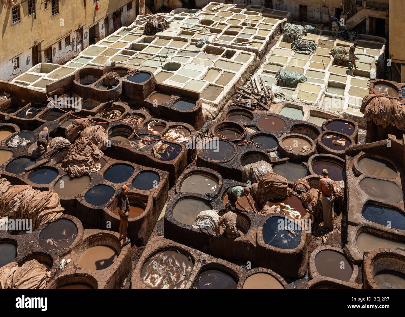 Fez, Morocco, May 1, 2025. Detail of vats of dye at the Chouara Tannery ...