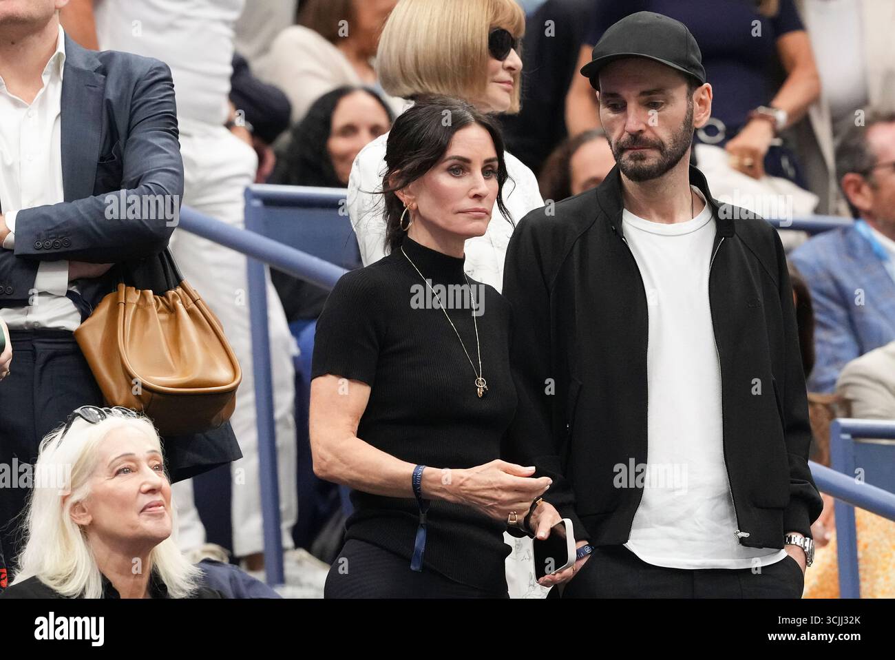 Johnny McDaid and Courtney Cox, wait for the start of the men's singles ...