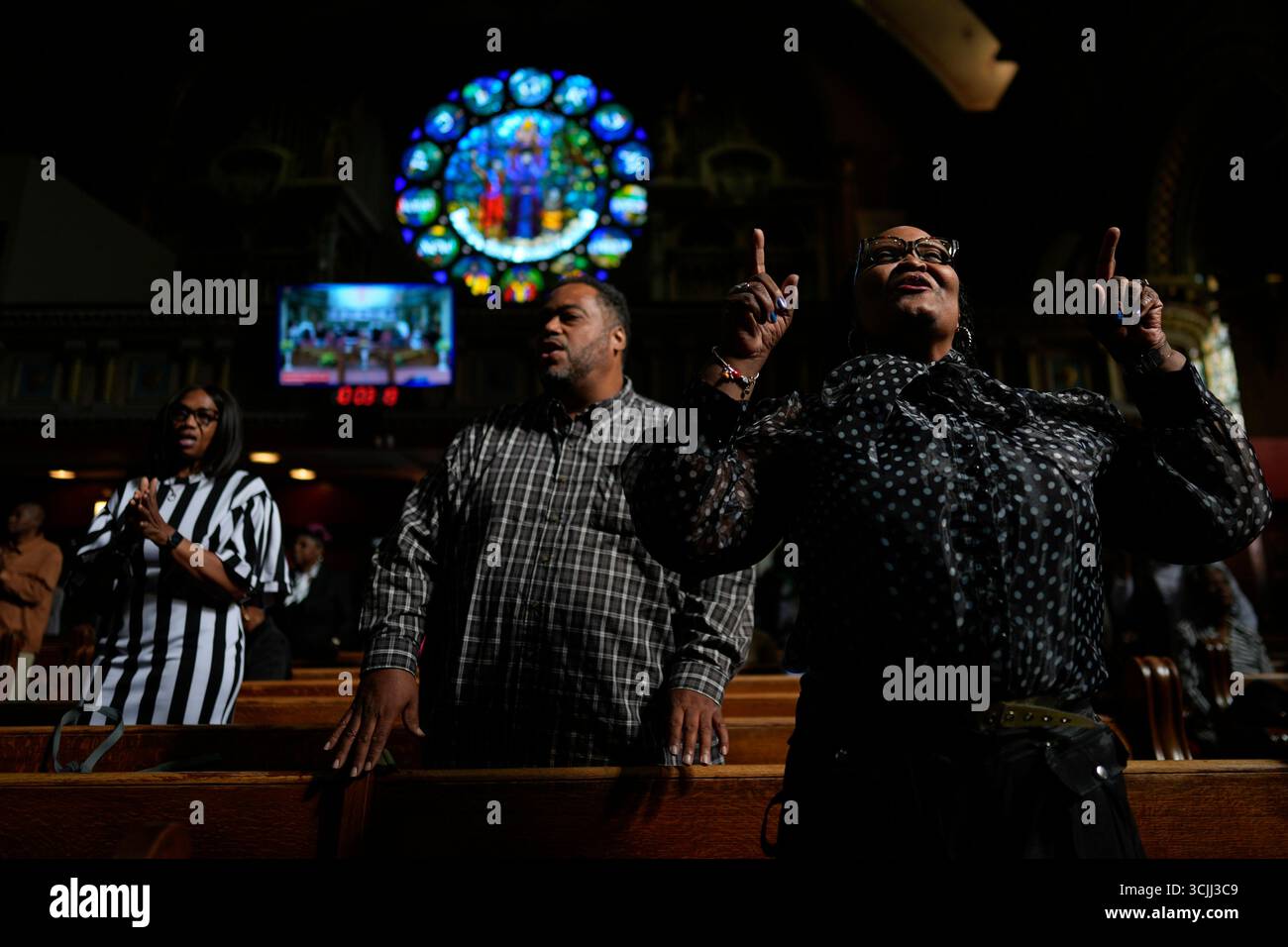 Evette Ervin, right, worships with the congregation during a service at ...