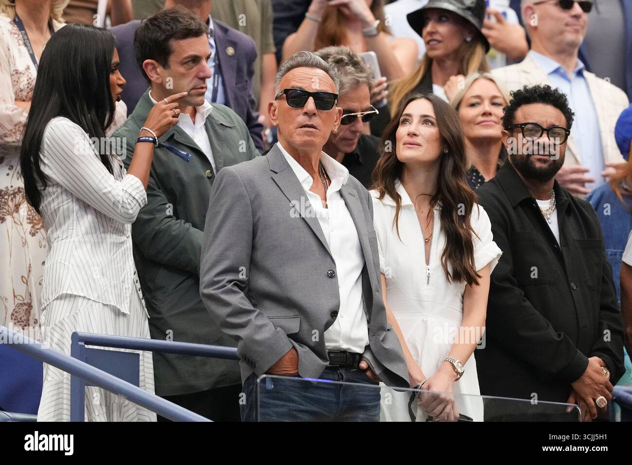Bruce Springsteen, left, waits for the start of the men's singles final ...