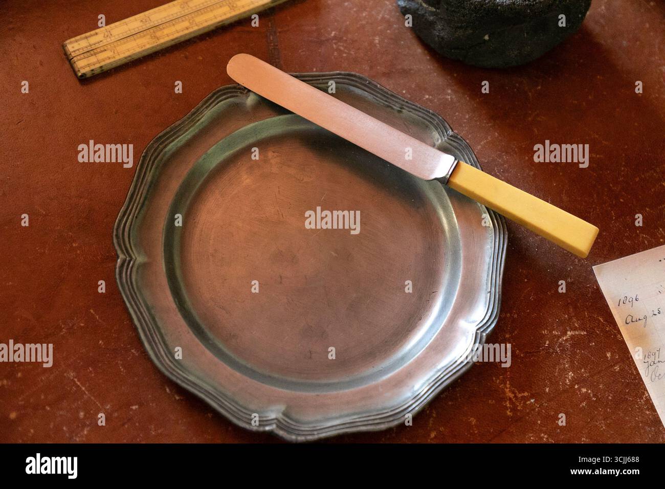 Old school silver plate and old knife with yellow handle Stock Photo ...