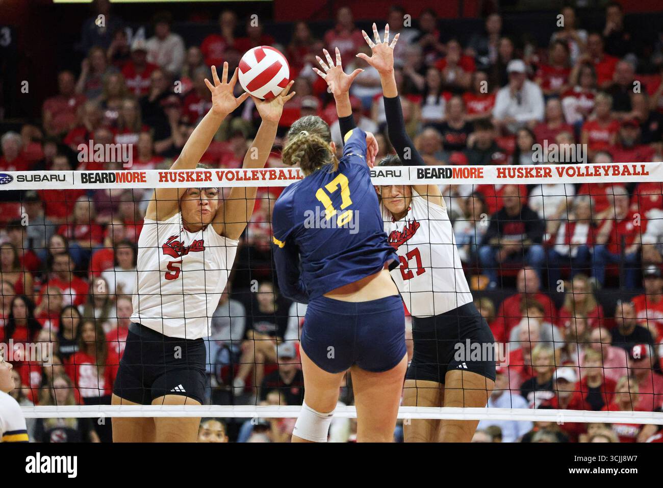 Nebraska's Rebekah Allick (5) blocks a strike by California's Arissa ...