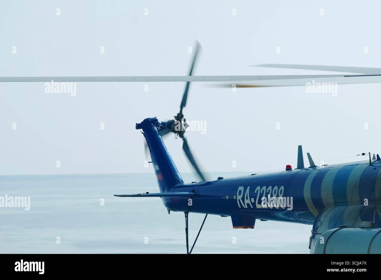 Tail section of a helicopter, rear rotor against the sea horizon Stock ...