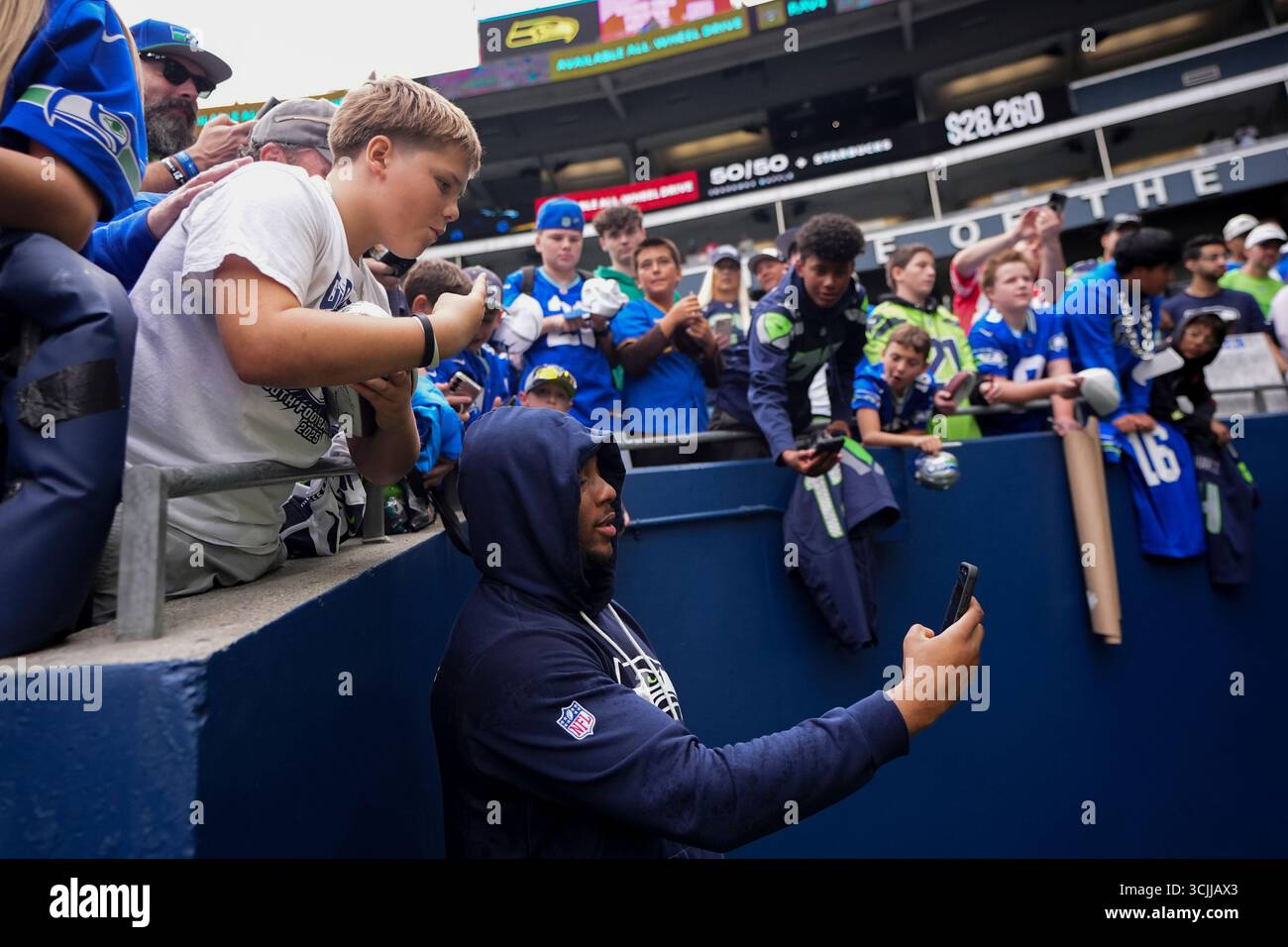 Seattle Seahawks linebacker Uchenna Nwosu (7) poses for a photo with a ...