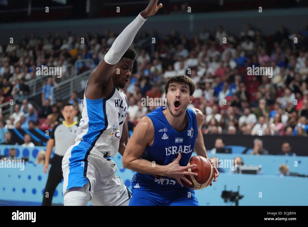 Israel's Roman Sorkin tries to shoot while defended by Greece's Kostas ...